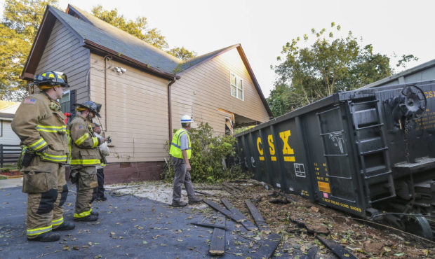 Freight train derails, sending train car into home; 1 hurt - News ...